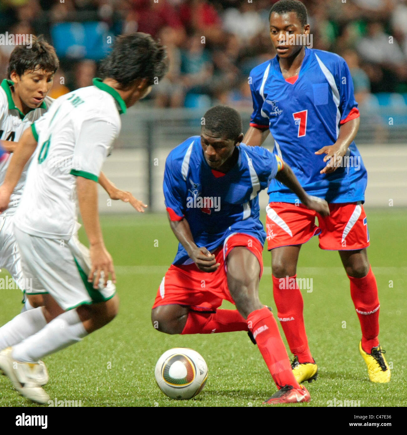 Haiti's Daniel Gedeon(center) attempts to shake off his Bolivian ...