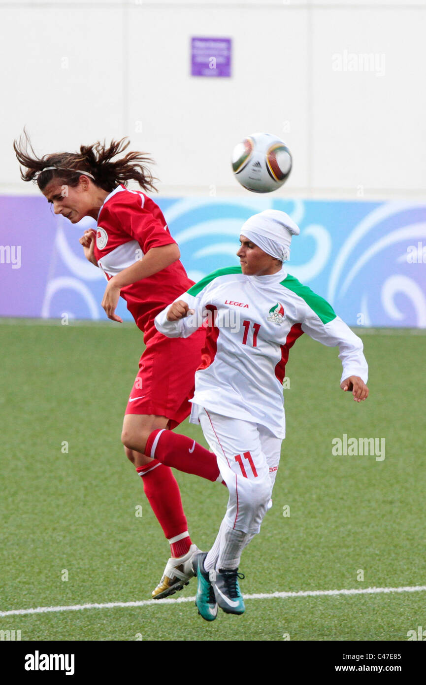 Iran's Behnaz Taherkhani(white) jumps for the aerial challenge Stock ...
