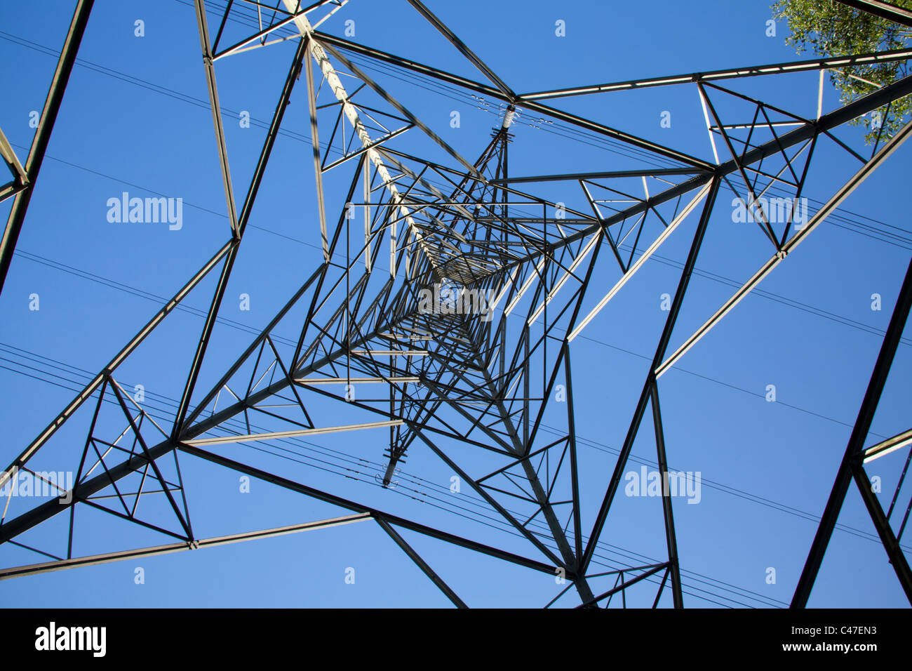 Upward view of electricity pilon with blue sky Stock Photo - Alamy