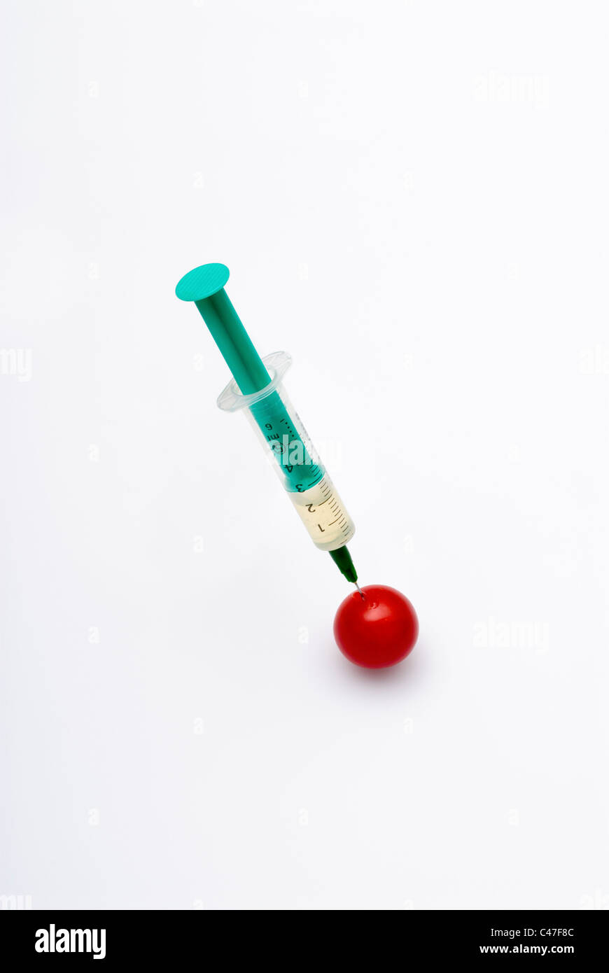 Tomato with syringe injection Stock Photo - Alamy