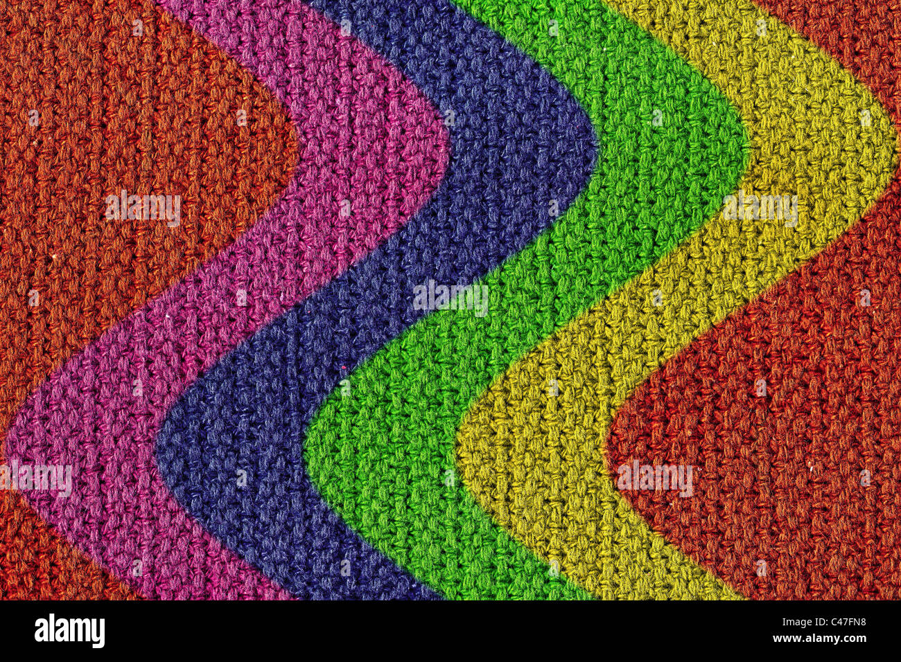 A texture background of a woven wool texture with curving colored ...