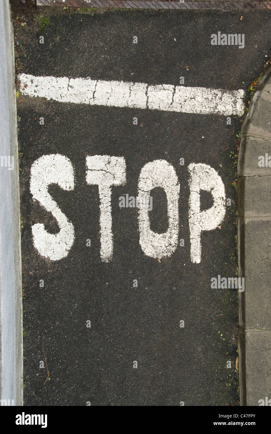 Hand written Stop sign and white line in on a small tarmac or blacktop ...
