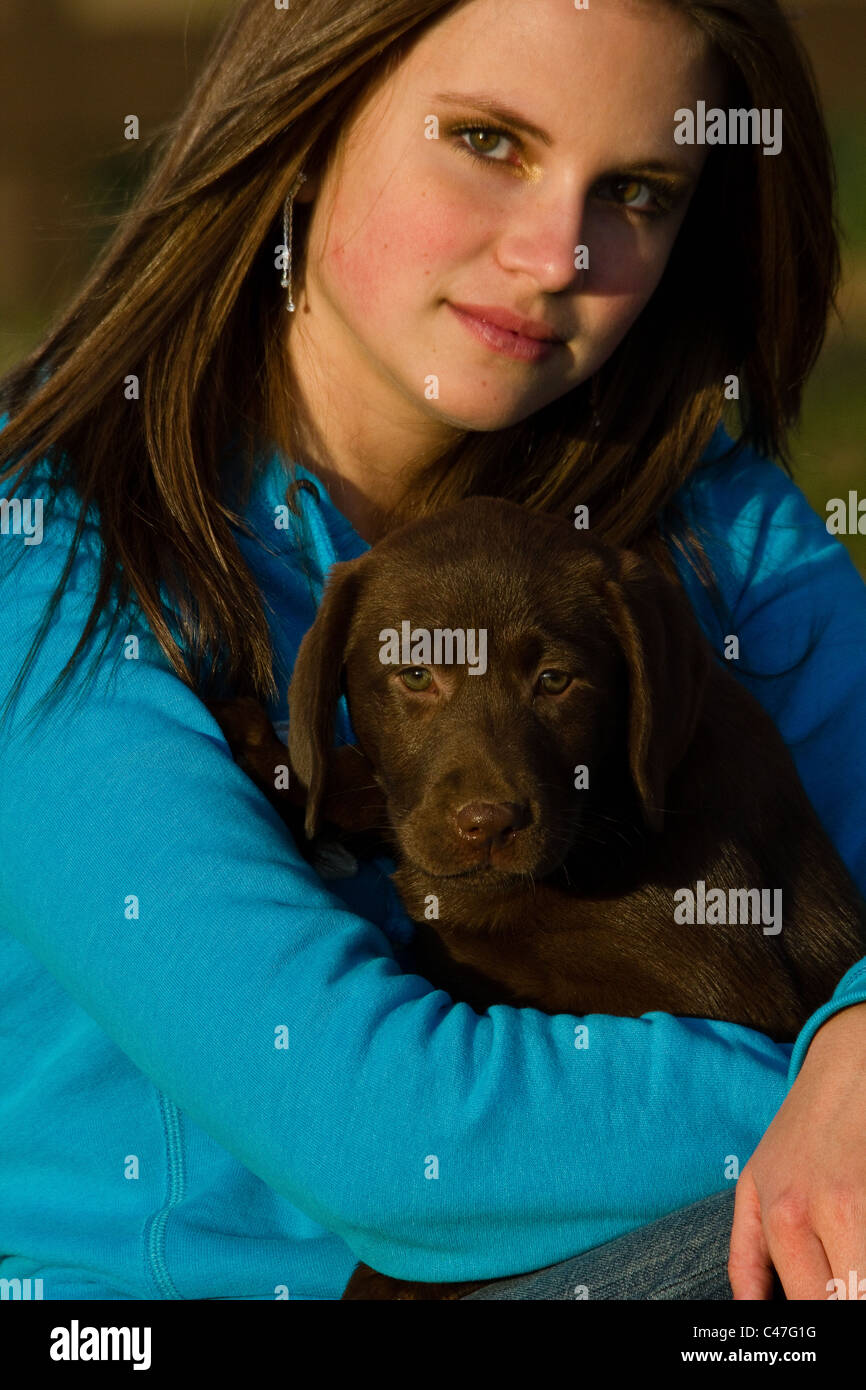 Young woman and Labrador retriever puppy Stock Photo - Alamy