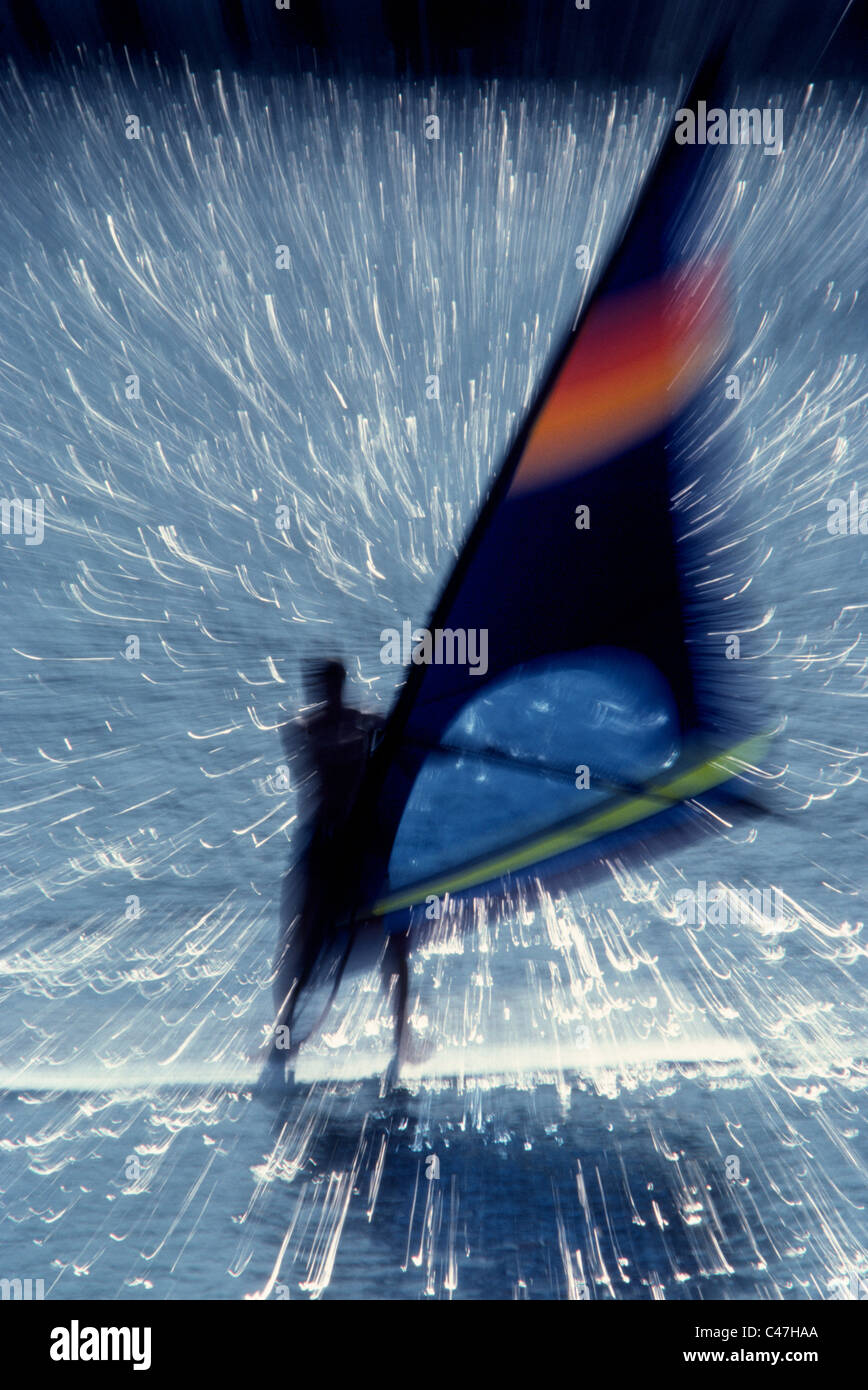 The motion of a windsurfer is enhanced by zooming the camera lens ...