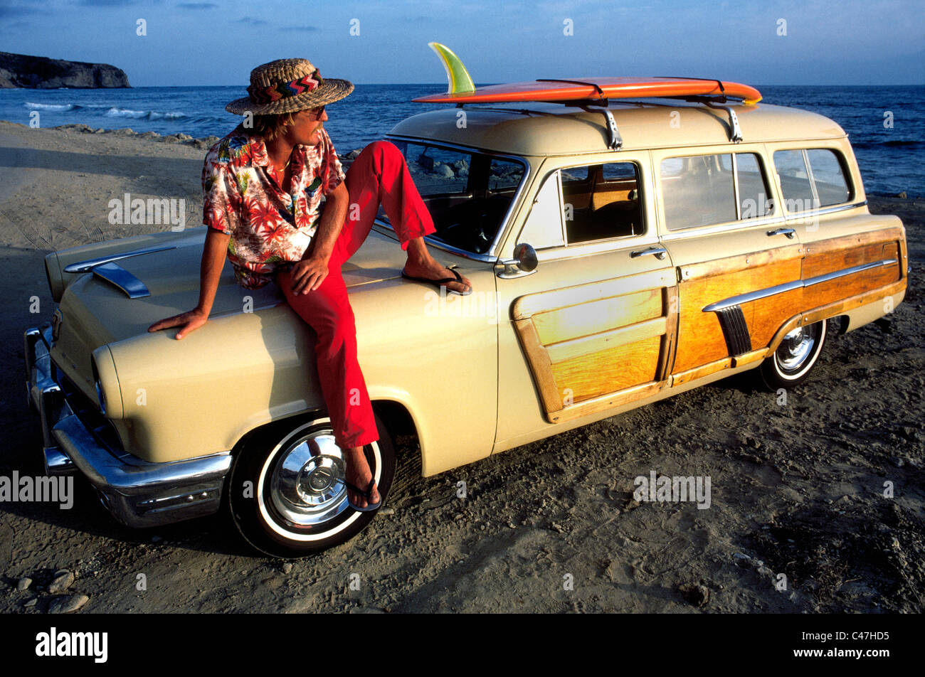 A California surfer relaxes on his classic 1952 Mercury woodie station ...