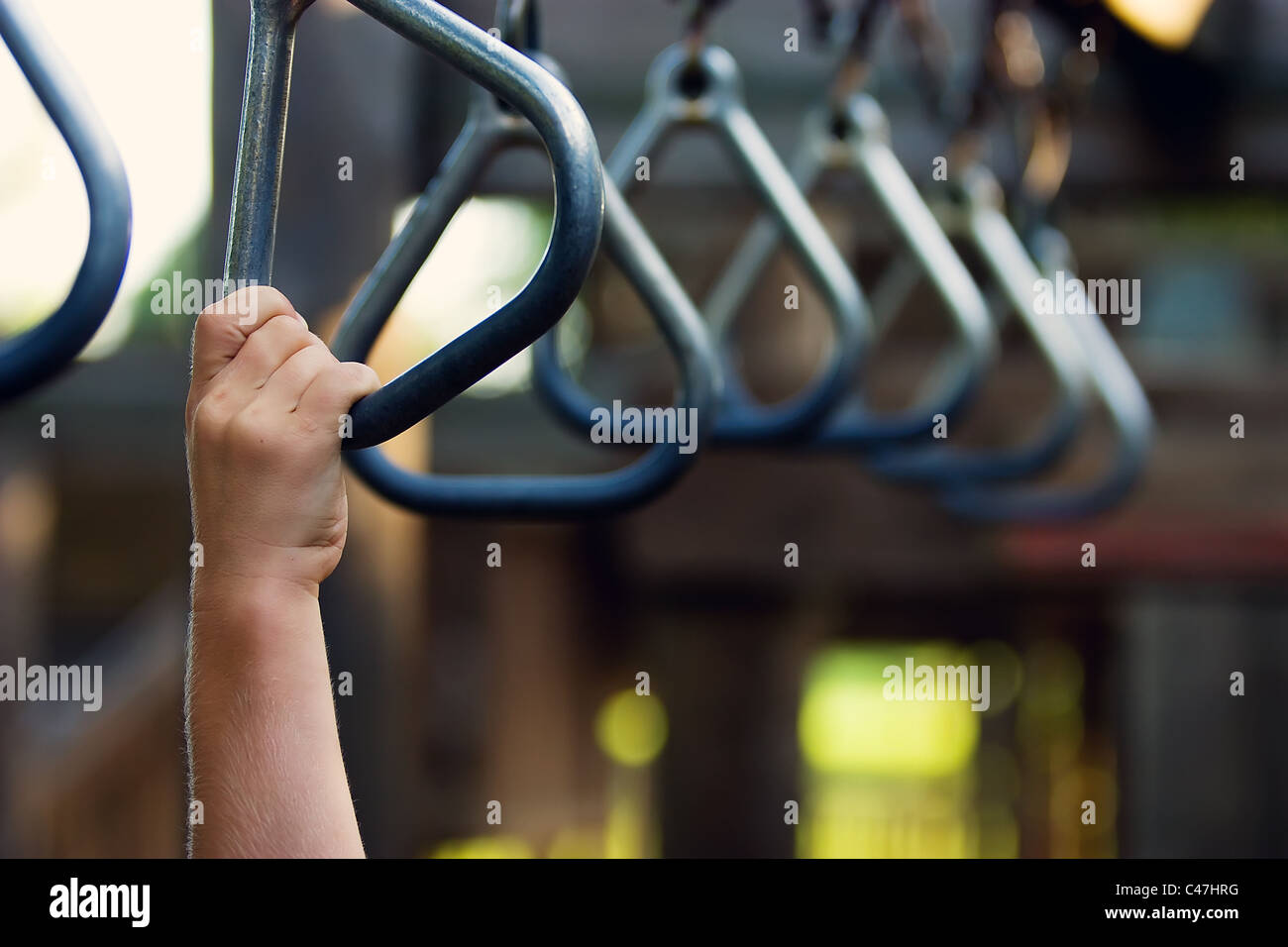 Boy's hand holding onto monkey bars Stock Photo - Alamy