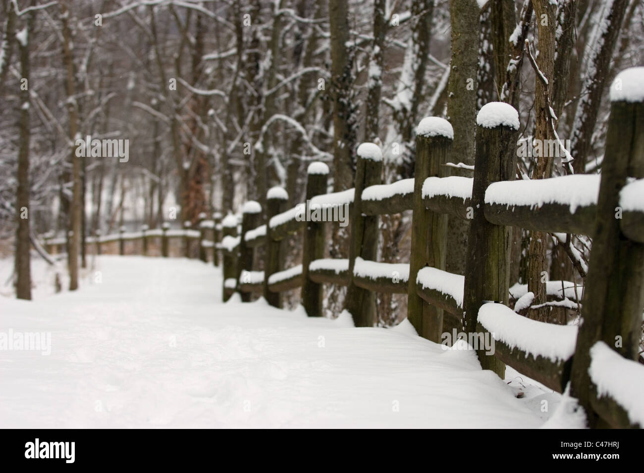A snow covered fence along a walking trail Stock Photo - Alamy