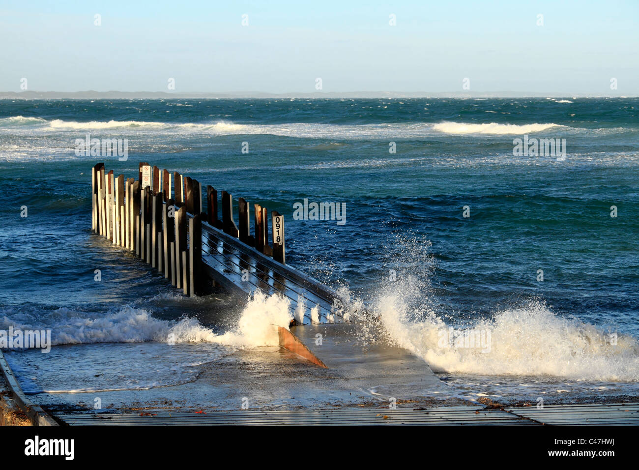 Waves breaking onto pier at Peel Inlet, Augusta Southwest Australia ...