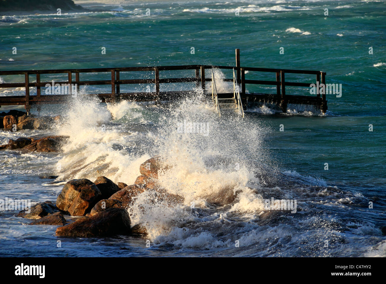 Waves breaking onto pier at Peel Inlet, Augusta Southwest Australia ...