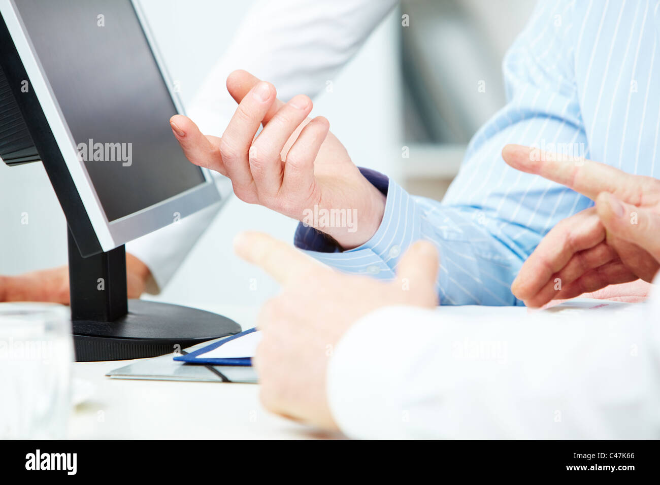 Image of human hands pointing at computer monitor during presentation ...