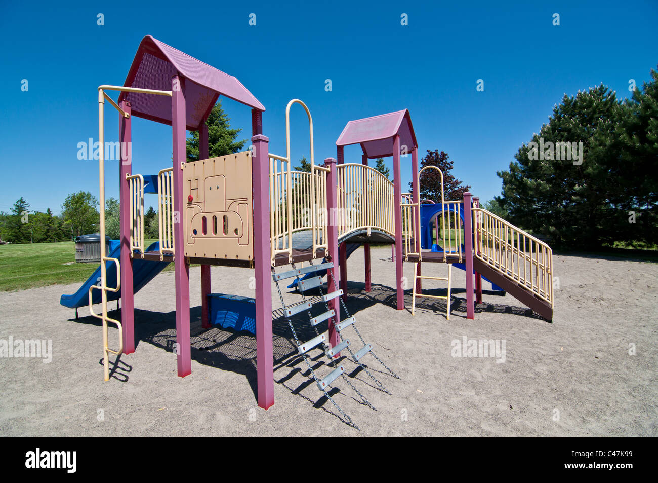A small neighborhood park with brightly colored playground equipment ...
