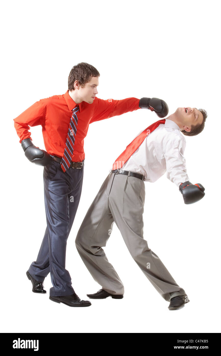 Portrait of aggressive businessman in boxing gloves kicking his rival ...