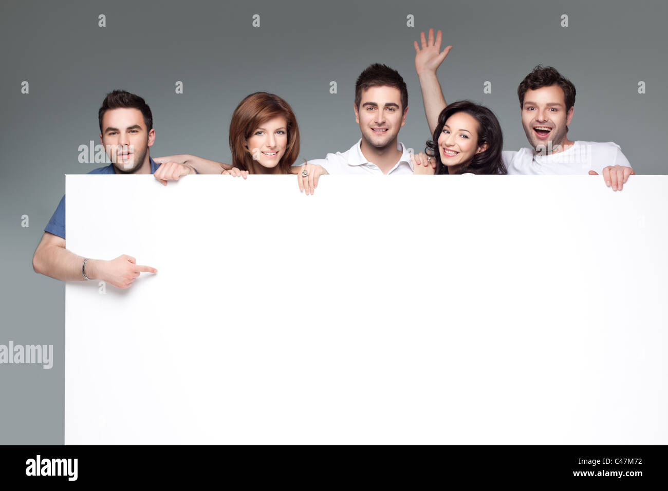group of funny friends holding a blank banner Stock Photo - Alamy