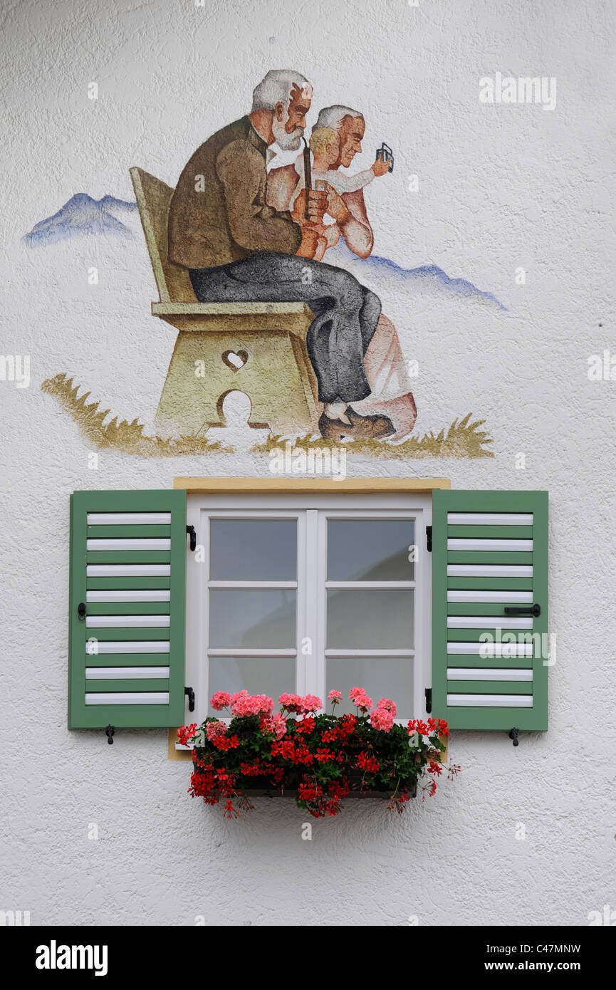 house facade and window decorated with traditional painting in Bavaria ...