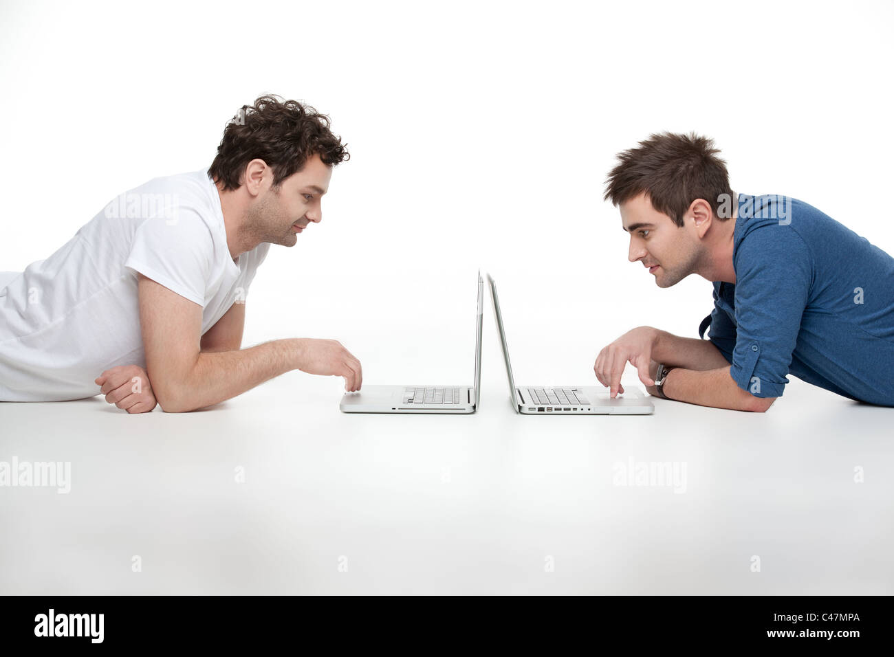 young handsome men looking at laptops Stock Photo - Alamy
