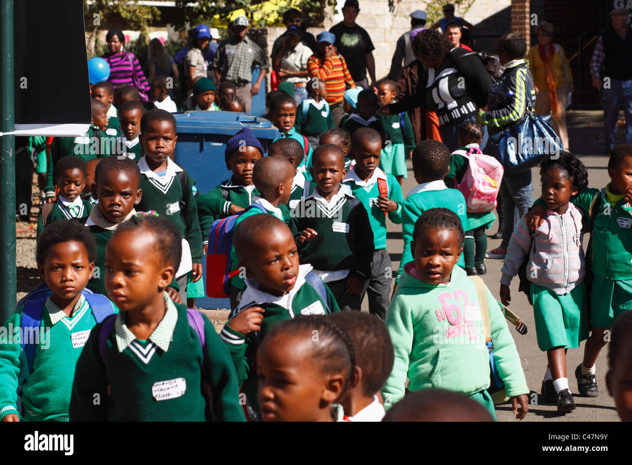 A large group of young school children on an educational excursion ...