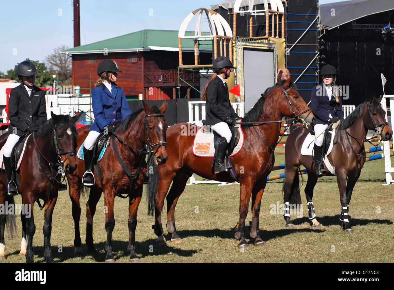 Four winners line up for prize giving in a young person's show jumping ...