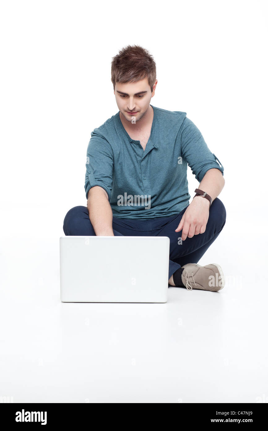 handsome man sitting looking at laptop Stock Photo - Alamy