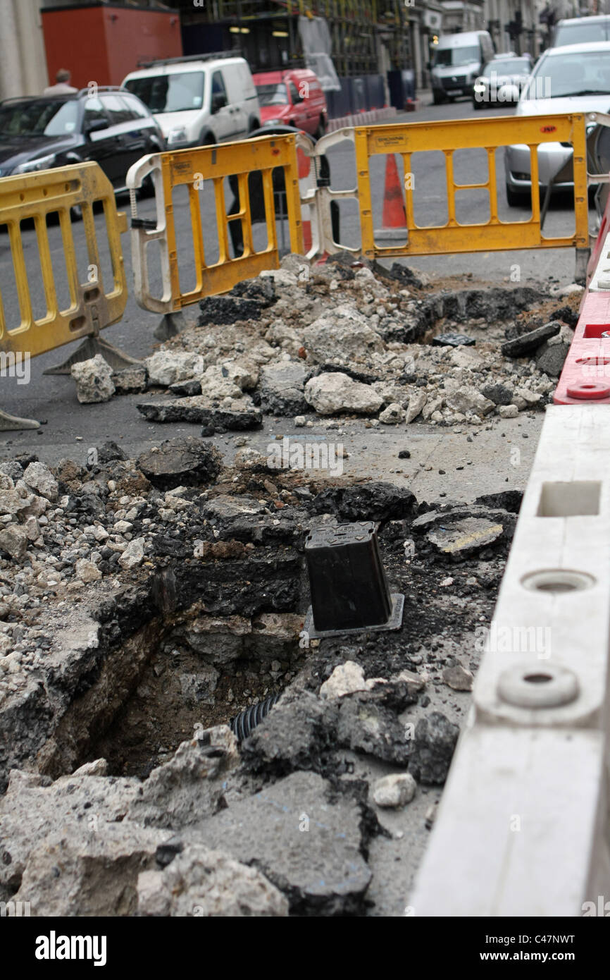 rubble around holes in a road during engineering works in London Stock ...