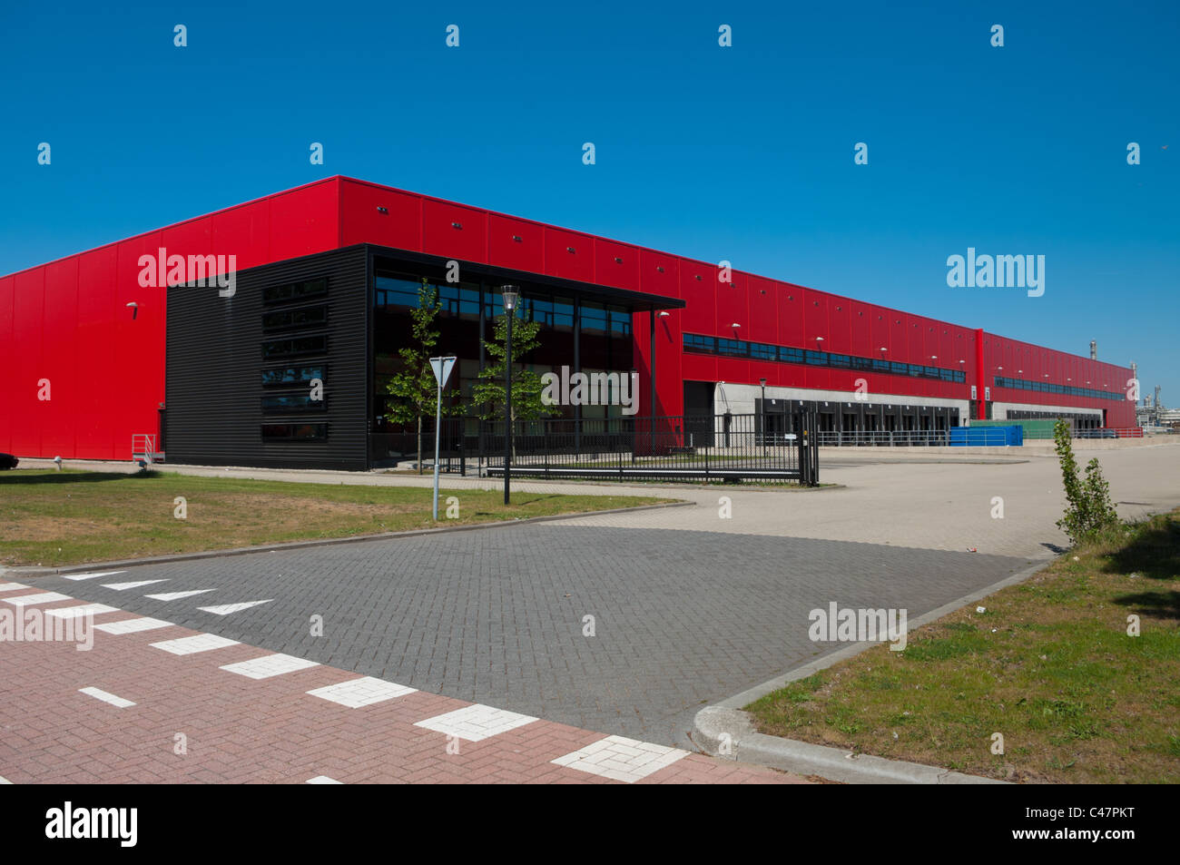modern red warehouse with office part and loading docks Stock Photo - Alamy