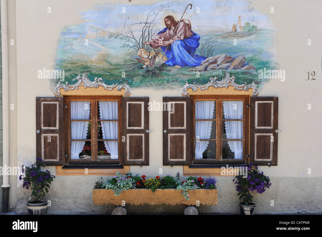 house facade and window decorated with traditional painting in Bavaria ...