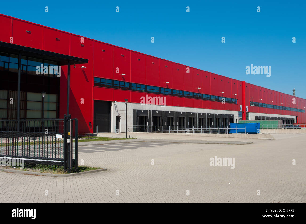 modern red warehouse with office part and loading docks Stock Photo - Alamy