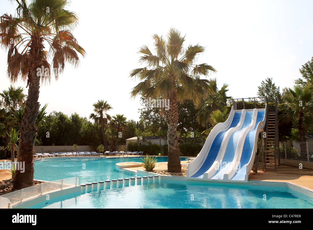 swimming pool with slides on holiday in tropical environment Stock ...