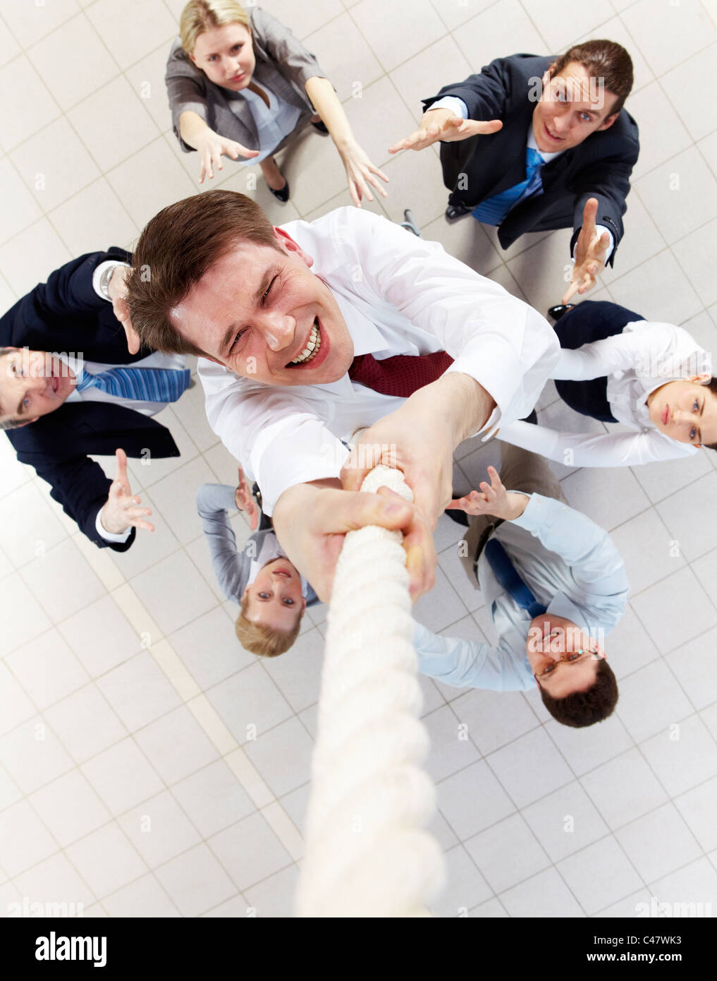 Above view of happy employer ascending up the rope with several ...