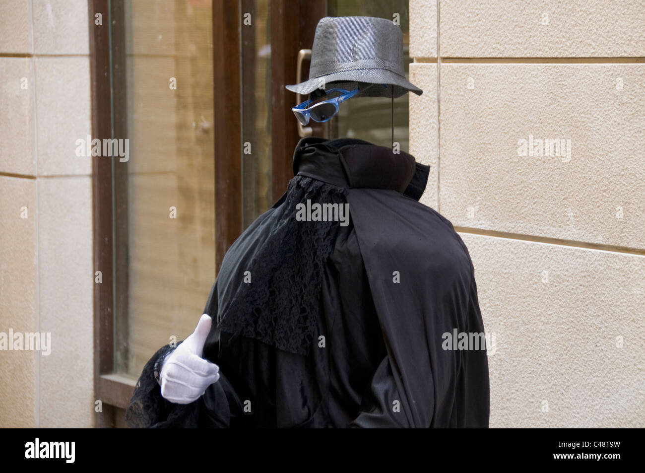A street performer becomes partially invisible in a street in Valencia ...