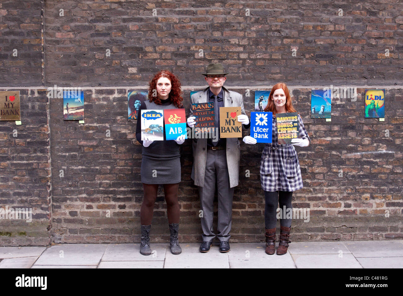 Supporters of a bank tax hold an anti-greed art giveaway of 300 signed ...