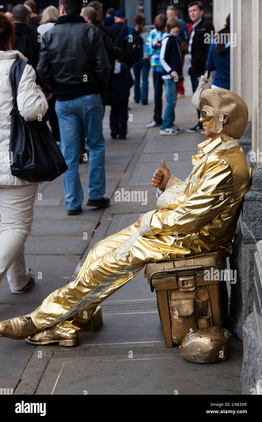 Man dressed in gold Elvis Presley suit and mask awaits donations from ...