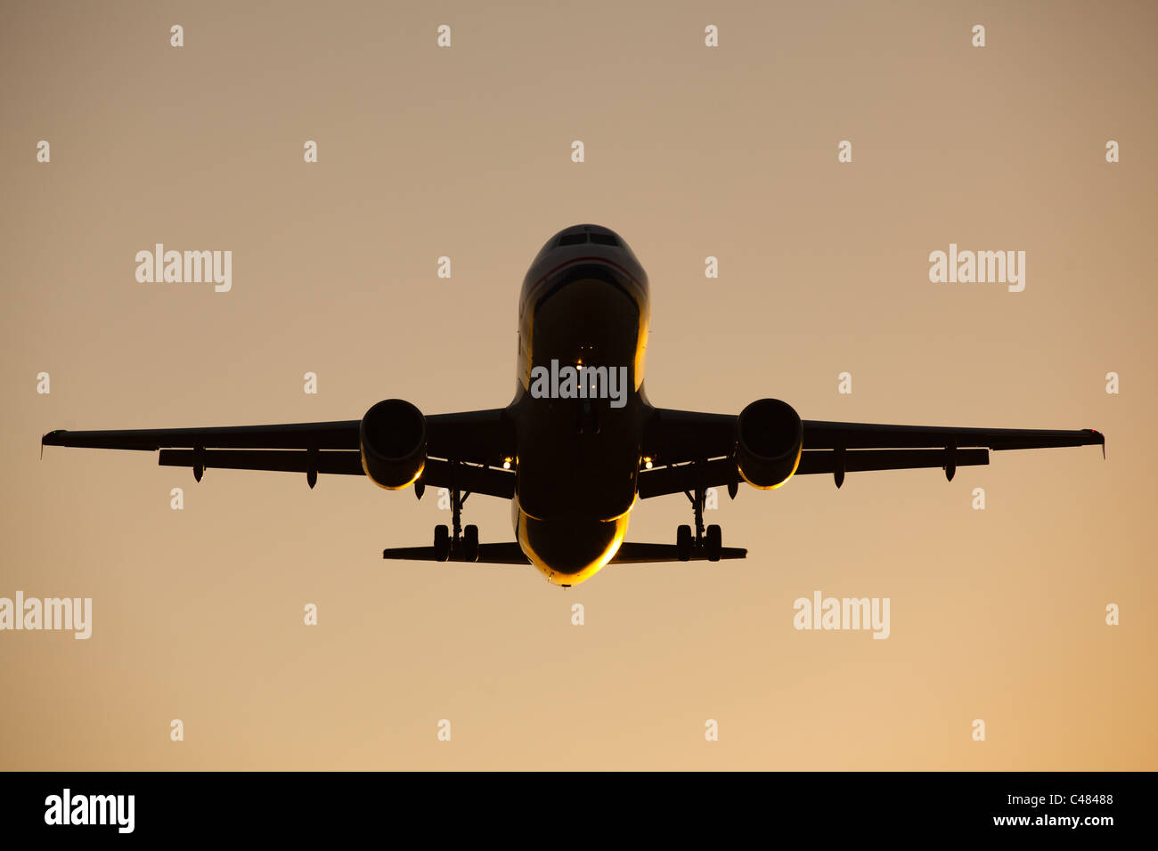 Flying aircraft at sunset Stock Photo - Alamy