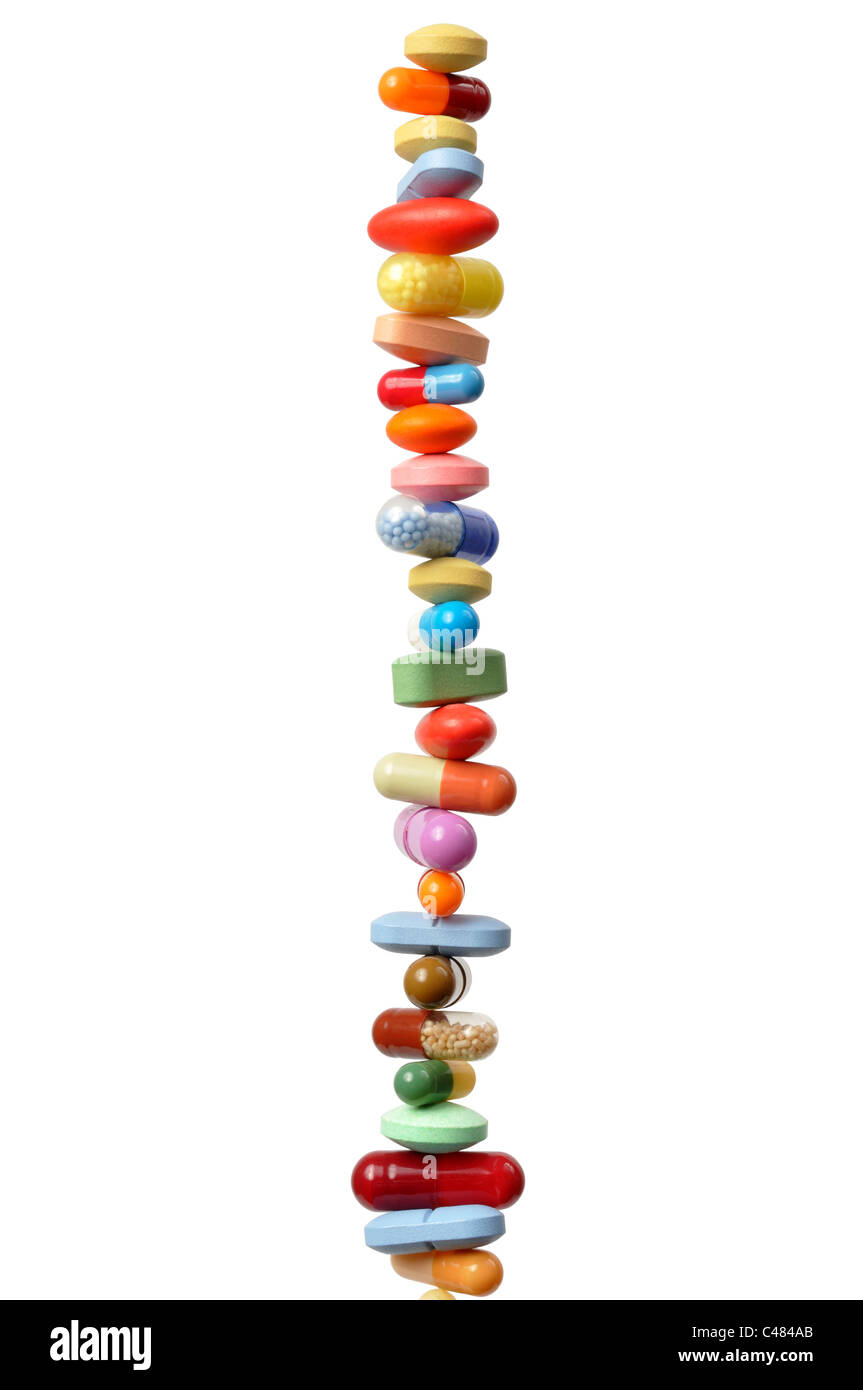 Stack of capsules isolated on white background Stock Photo - Alamy