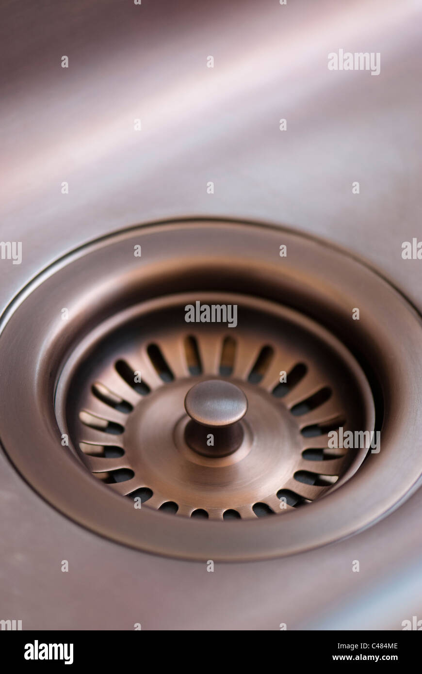 Dark bronze drain on bottom of the sink Stock Photo - Alamy