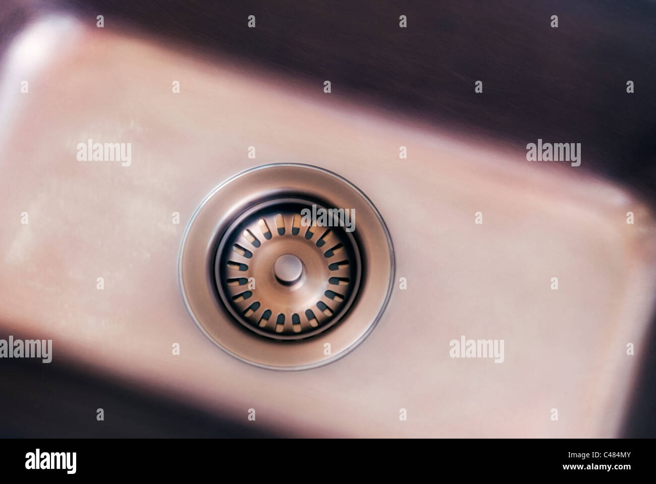 Dark bronze drain on bottom of the sink Stock Photo - Alamy