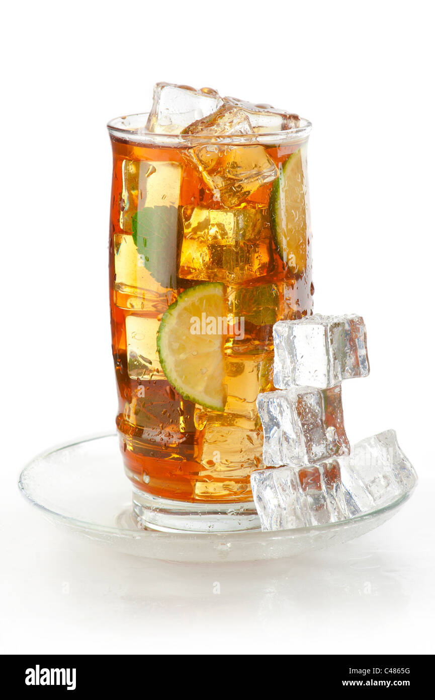 Glass of iced tea with ice cubes, lime and mint, covered with water ...