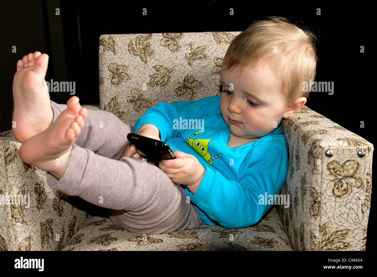 Baby texting on mobile phone Stock Photo - Alamy