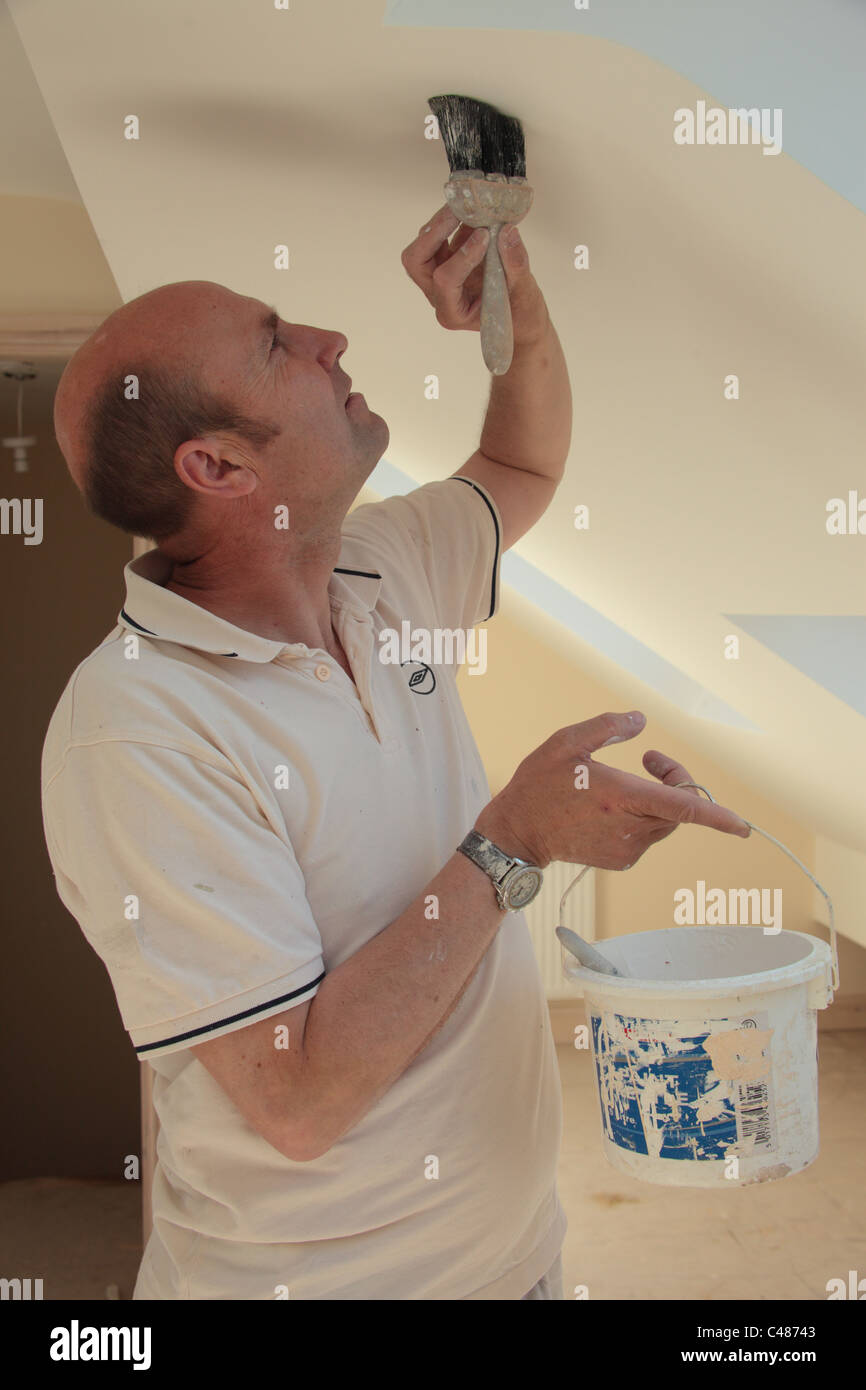 Painter painting interior of a house Stock Photo - Alamy