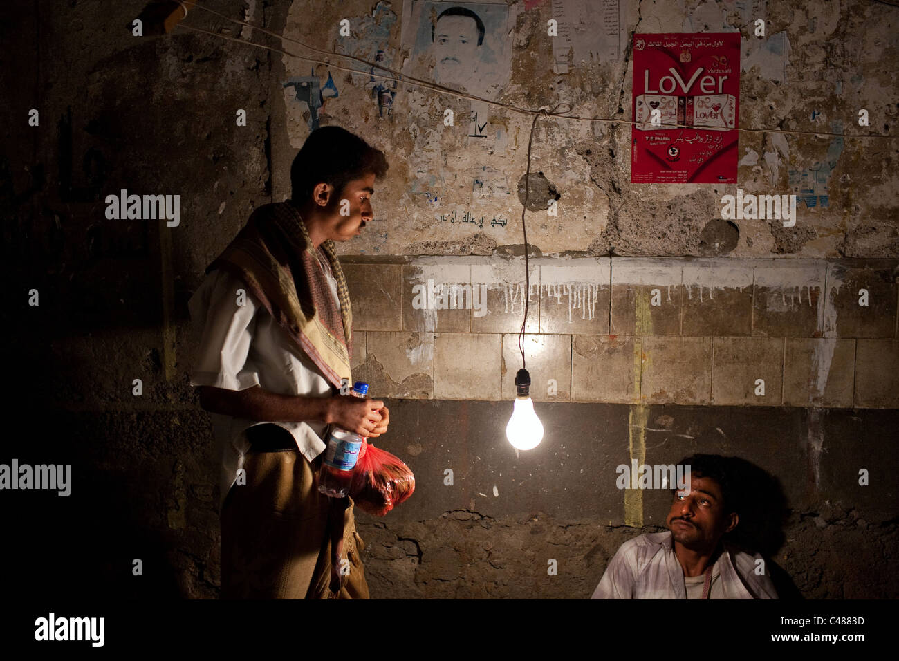 Two men selling khat at the night khat market in Aden, Yemen Stock ...