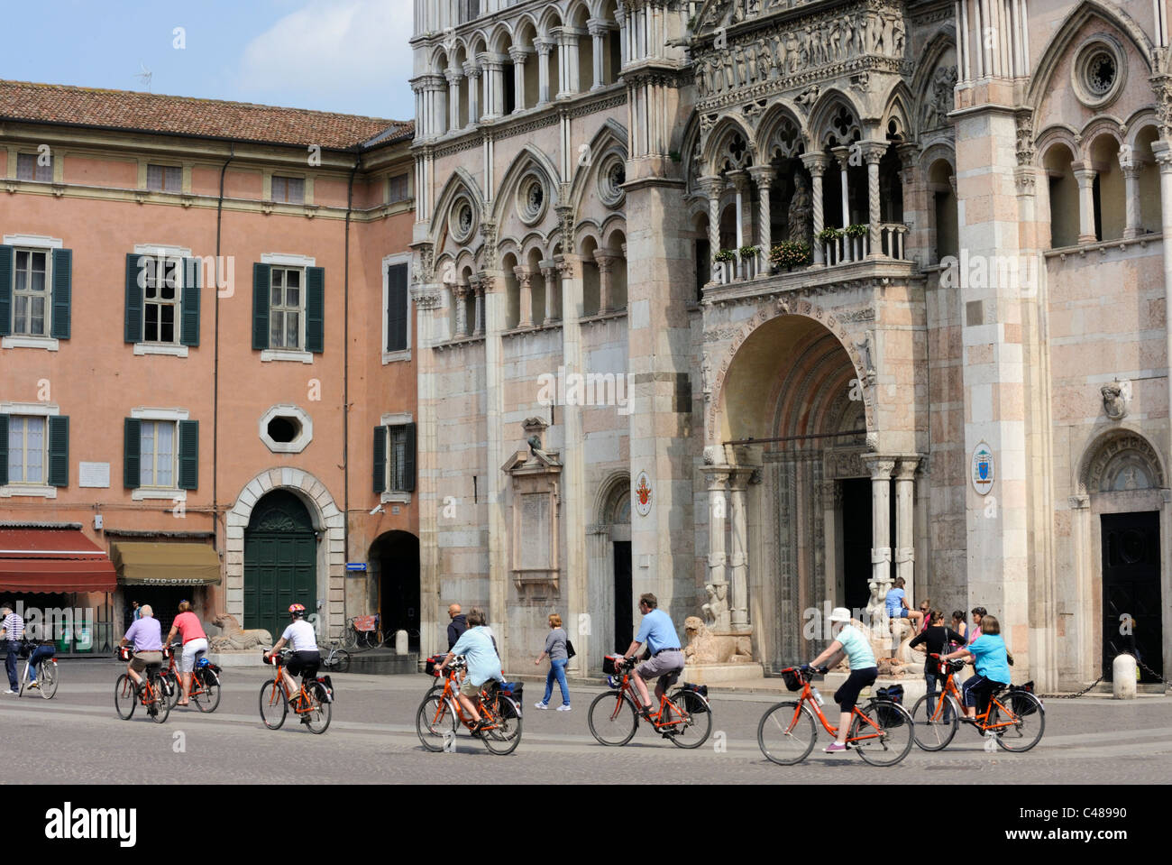 Cyclist's passing the duomo in Ferrara Stock Photo - Alamy