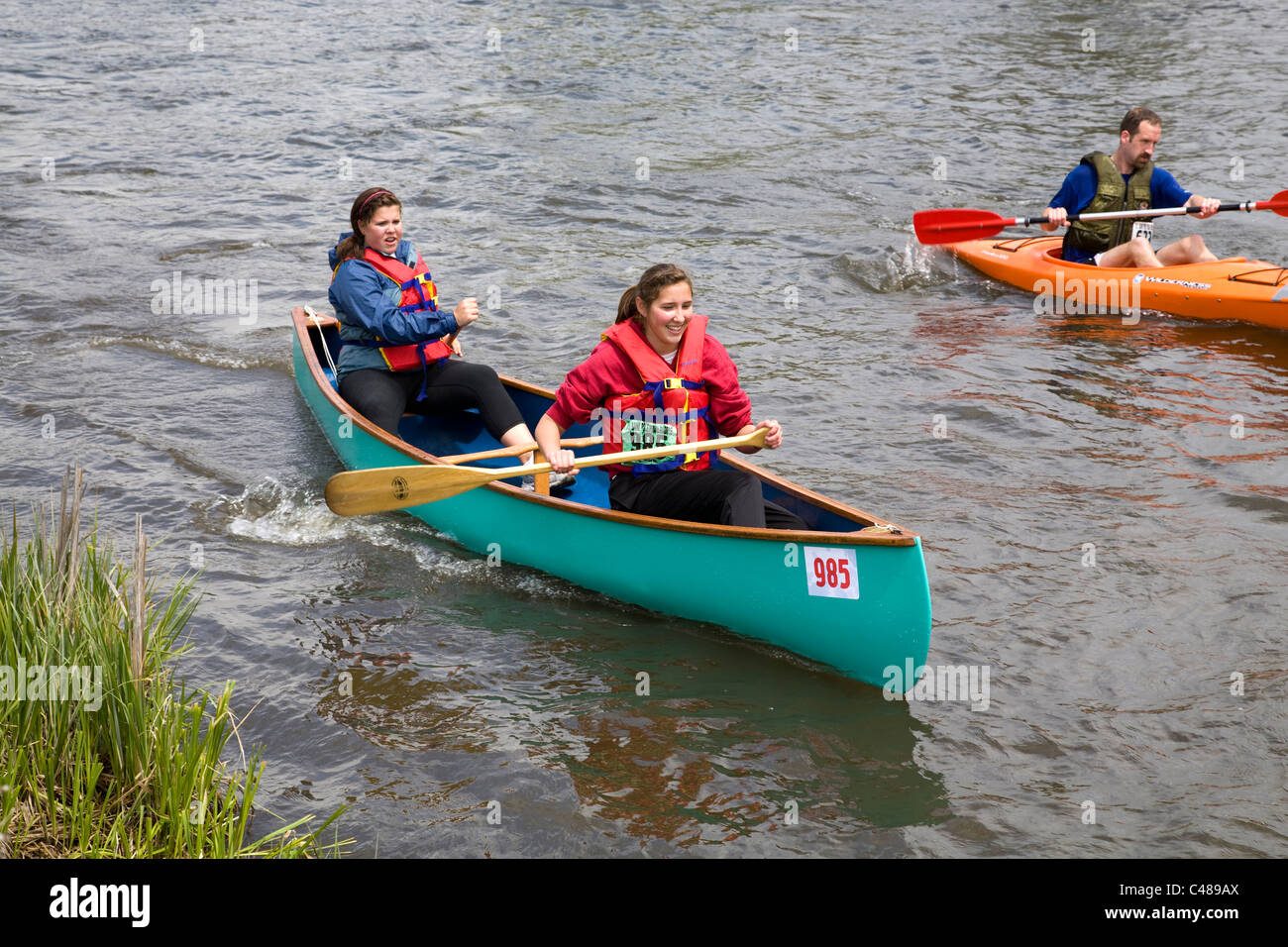 Two high school girls canoeing during the Pole, Pedal, Paddle race in ...