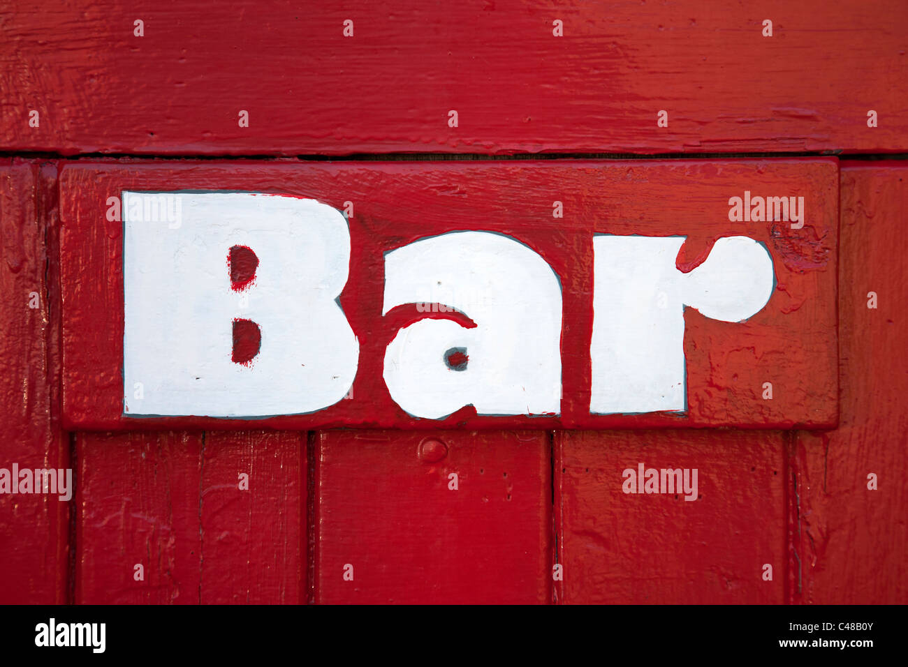 Bar sign on red wooden door Stock Photo - Alamy