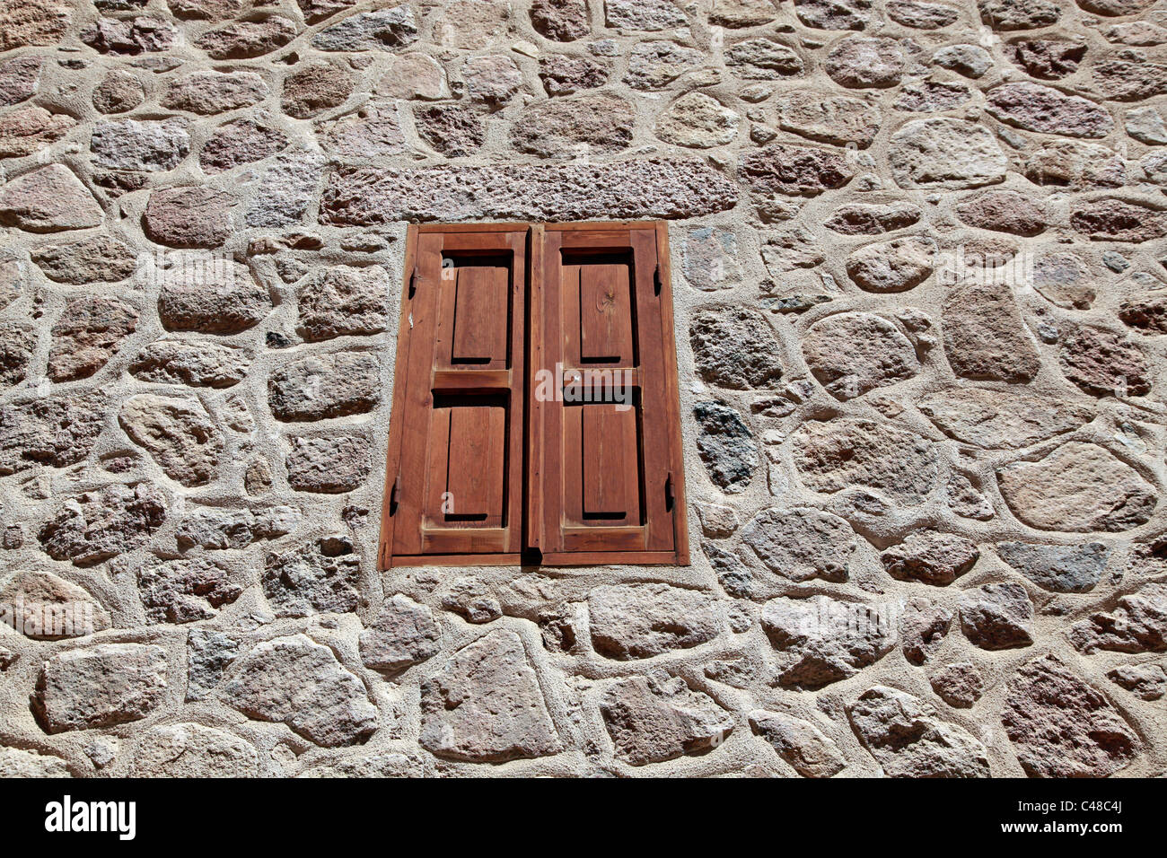 Shuttered window in a stone wall background at St. Catherine's ...