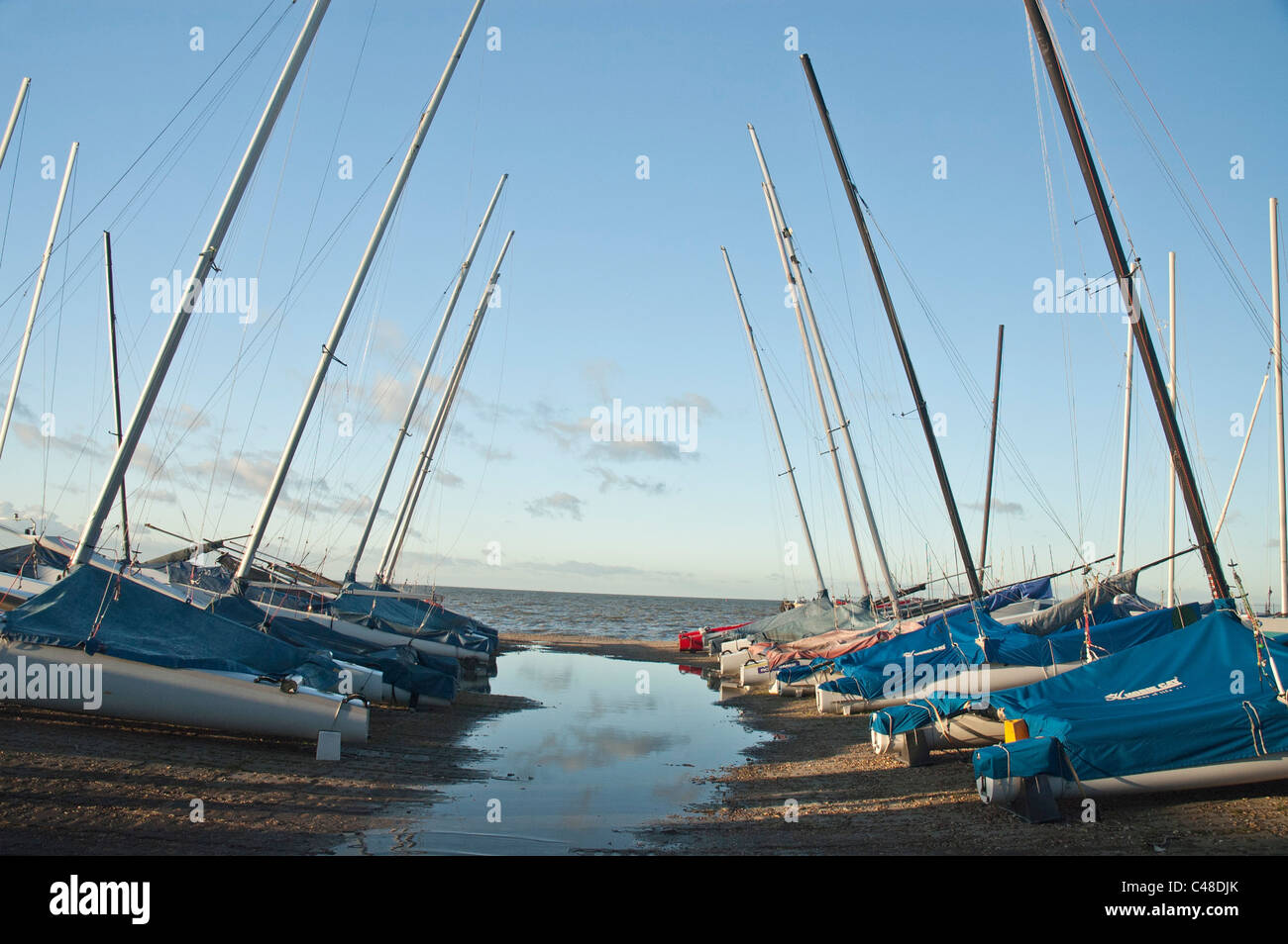 Yachts sailing dinghies on beach Whitstable Kent England Uk Stock Photo ...