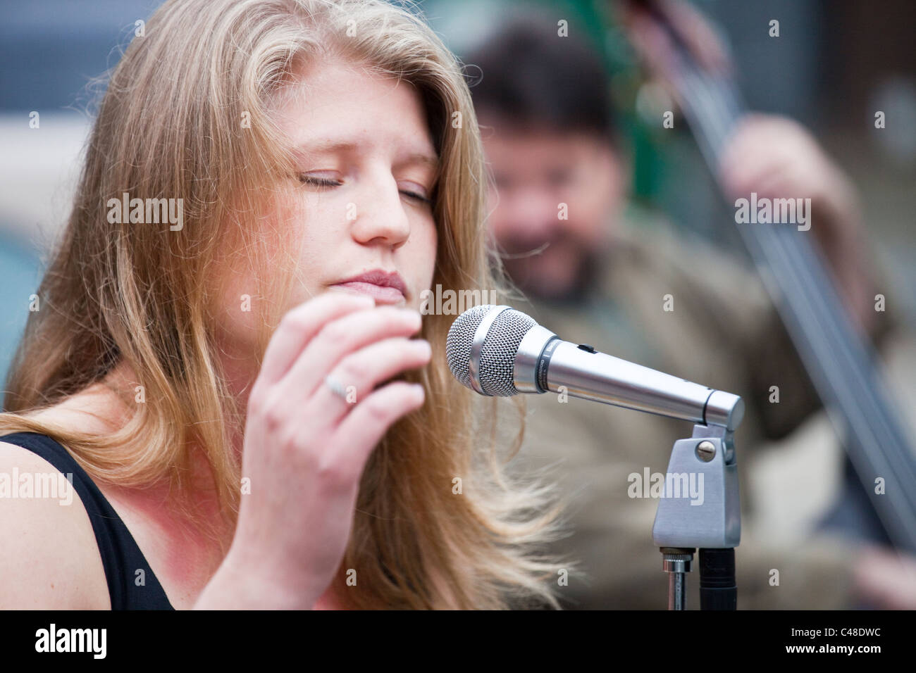 Blond haired woman singing hi-res stock photography and images - Alamy