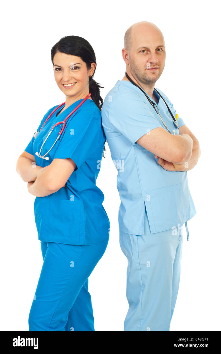 Happy team of two physicians standing back to back with arms folded ...