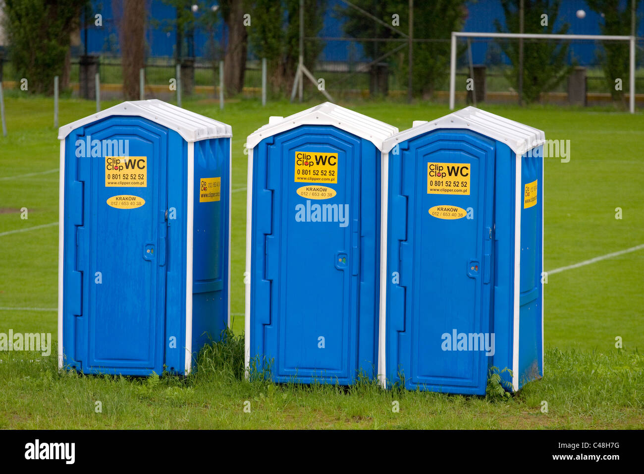 Blue mobile toilet cabins in an outdoor scene Stock Photo - Alamy