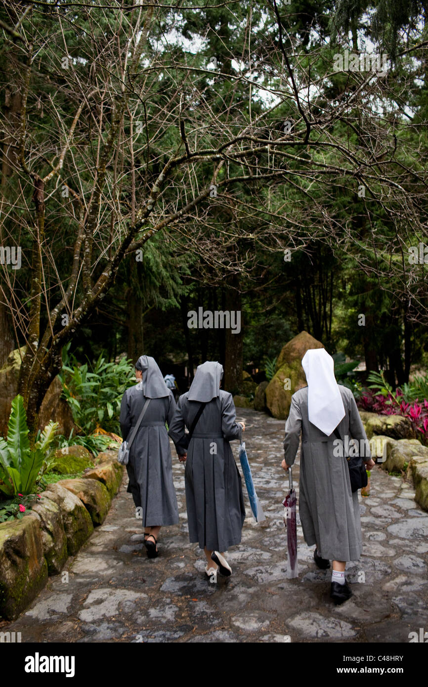 Nuns stroll the stone paths of the Formosan Aboriginal Village, Taiwan ...
