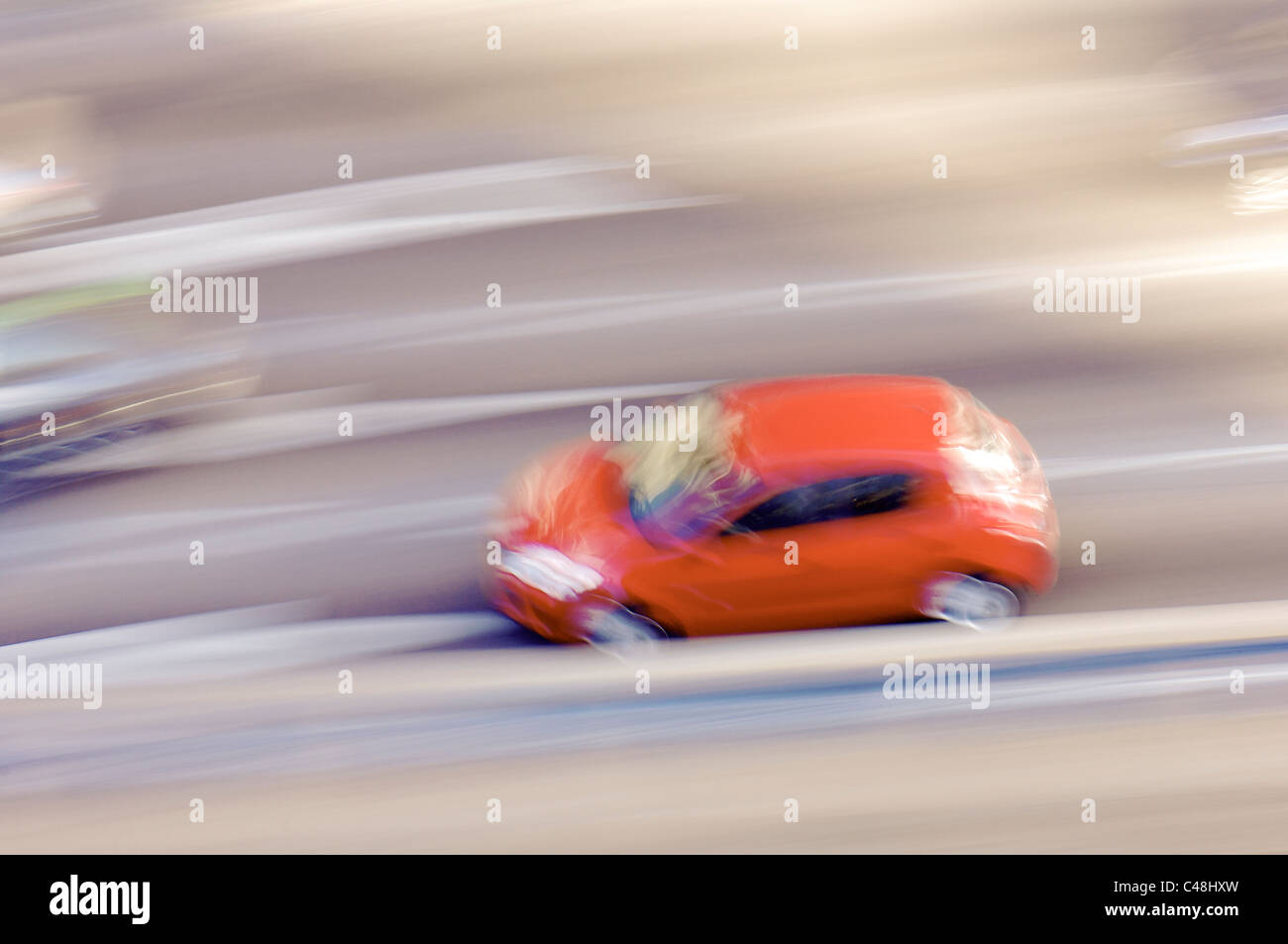 Red car in motion hi-res stock photography and images - Alamy