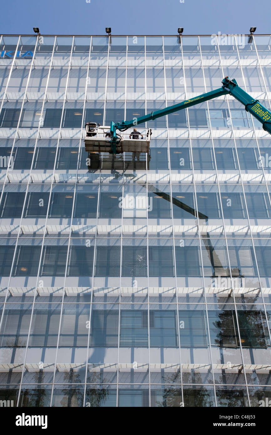 window cleaners working from elevator truck basket Stock Photo - Alamy